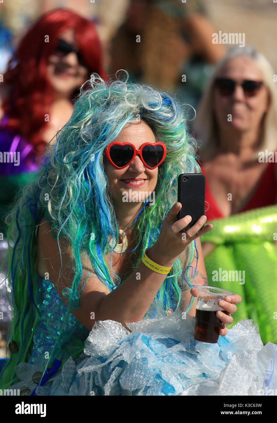 Participants dressed as mermaids gather in Bexhill-on-Sea in East ...