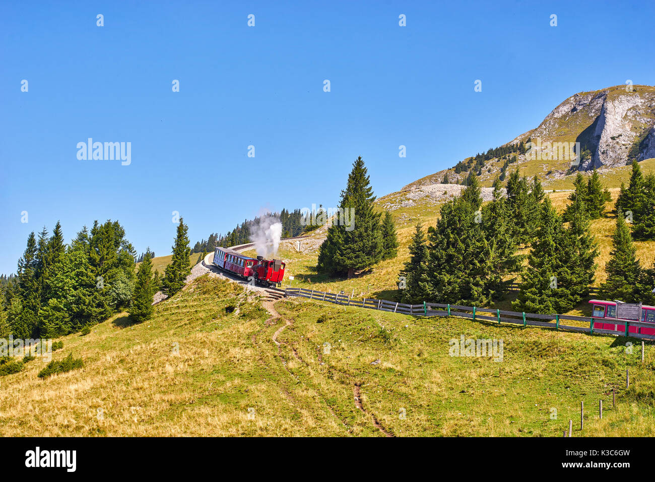 Excursion red train in mountains Stock Photo - Alamy