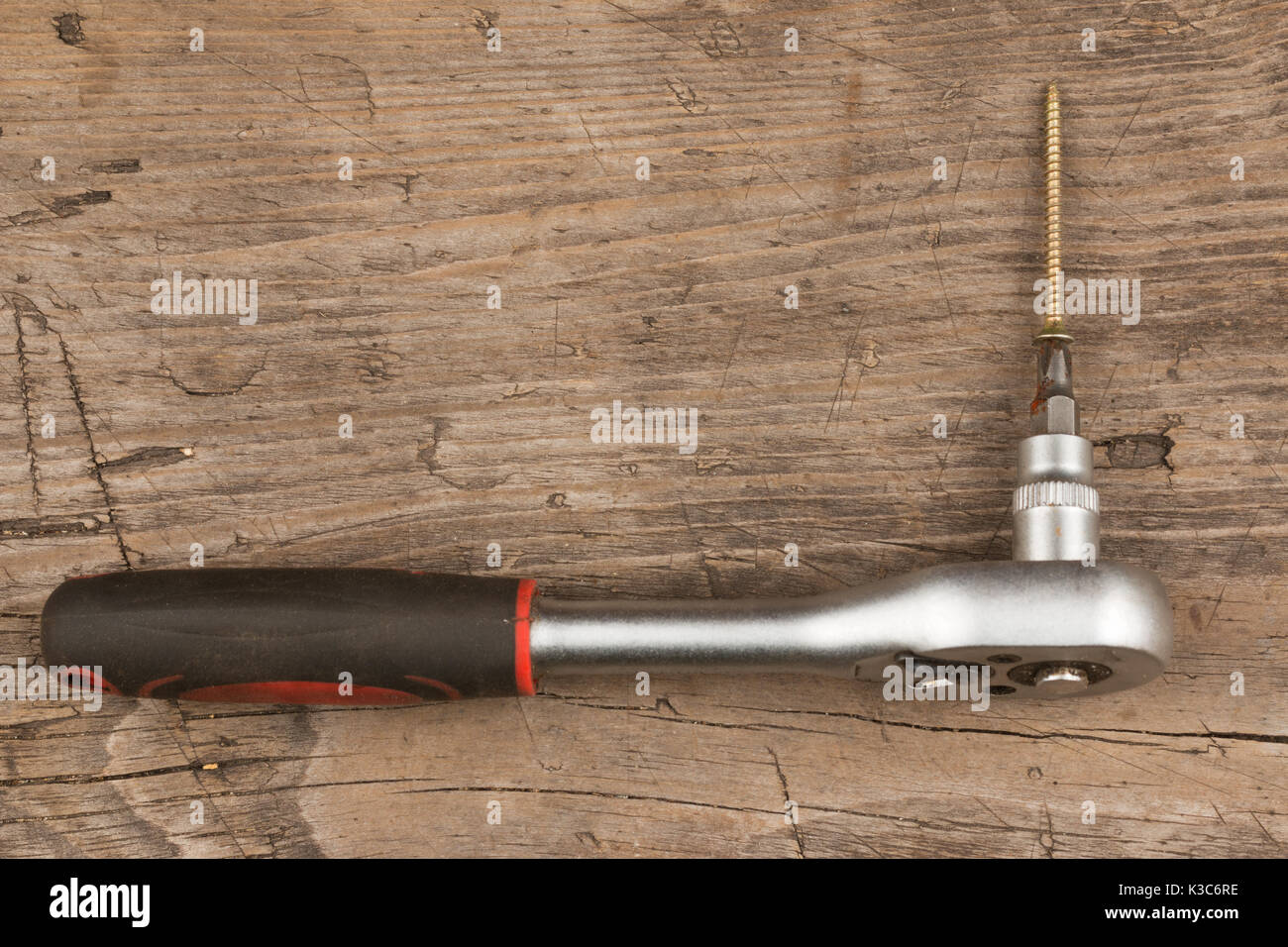 Screwdriver and screw on wooden board. Joinery and construction work ...