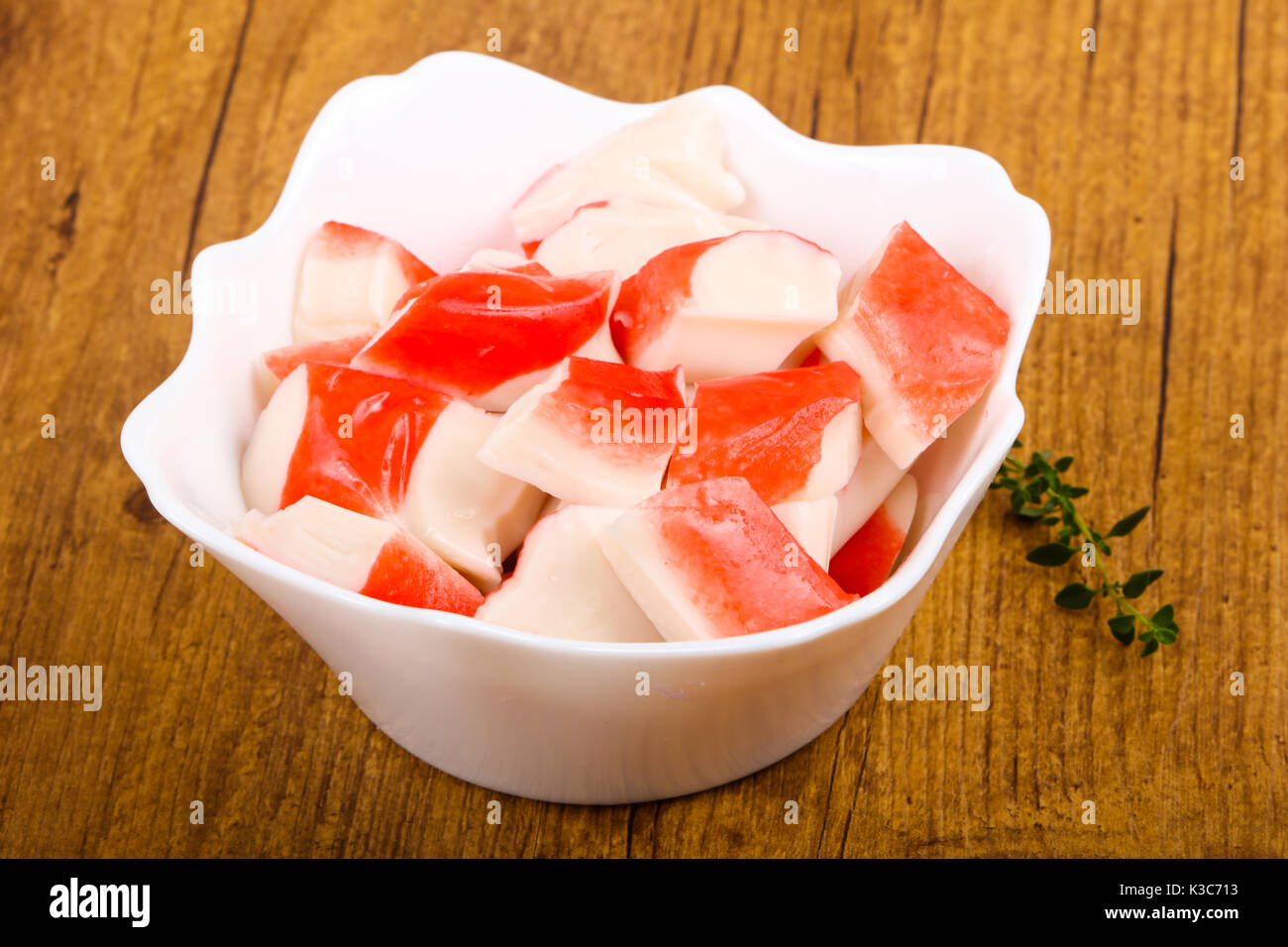 Crab stick - surimi in the plate - over wood background Stock Photo - Alamy
