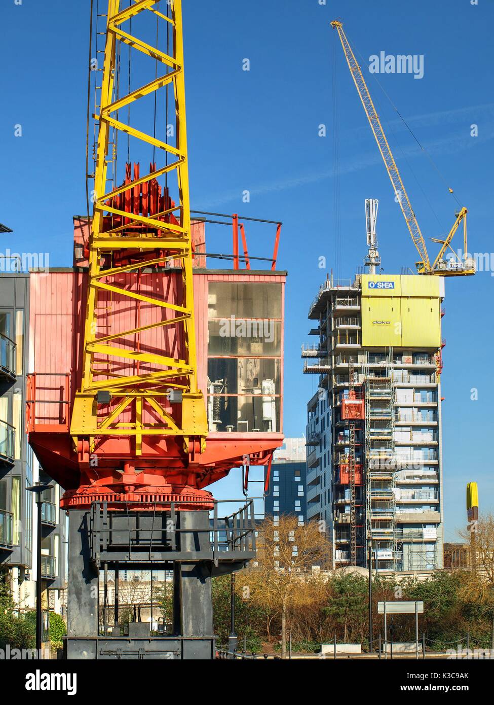 Refurbished vintage dockside crane painted red and yellow with modern ...