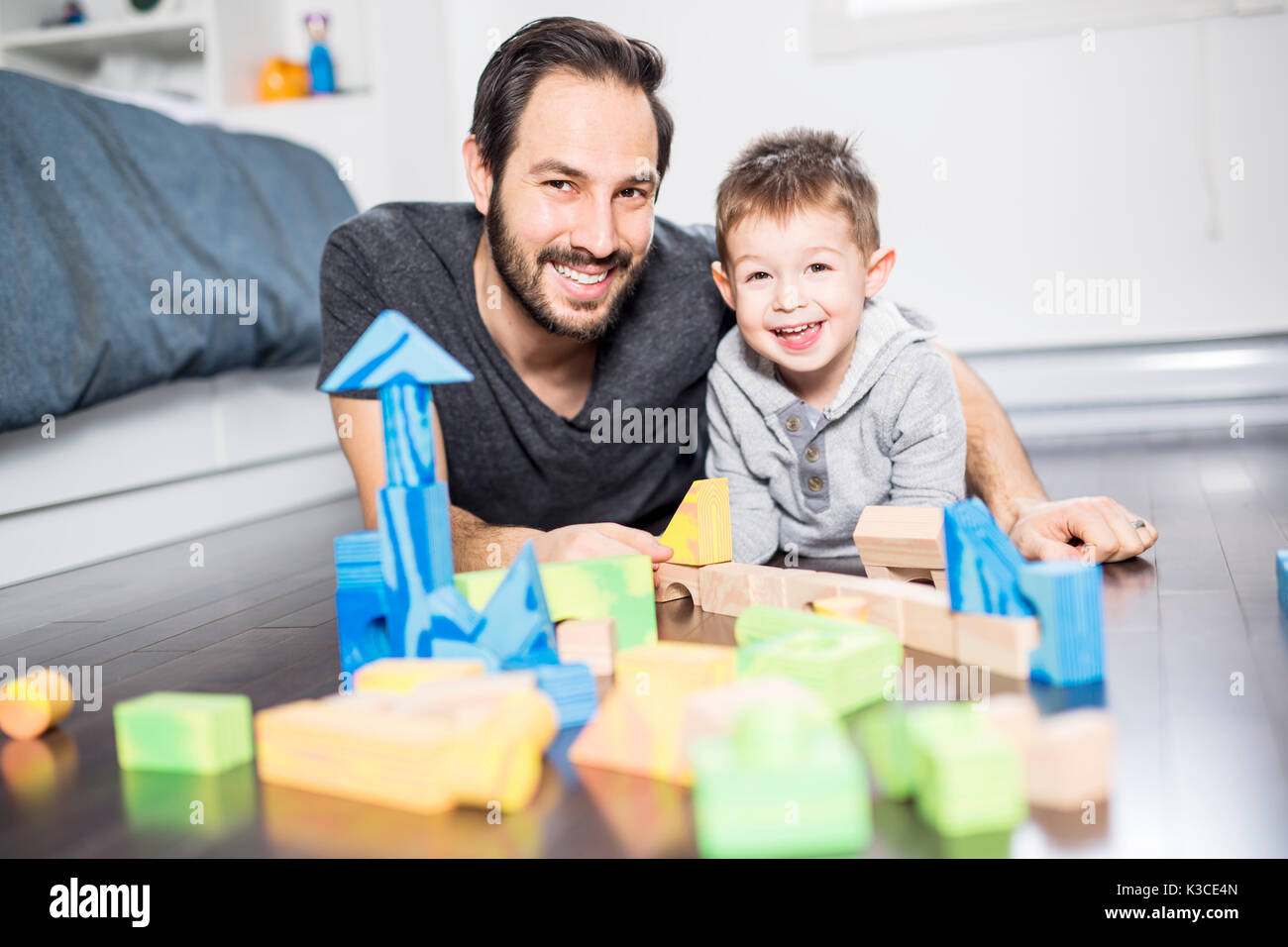 cute child playing with color toy indoor with is dad Stock Photo - Alamy