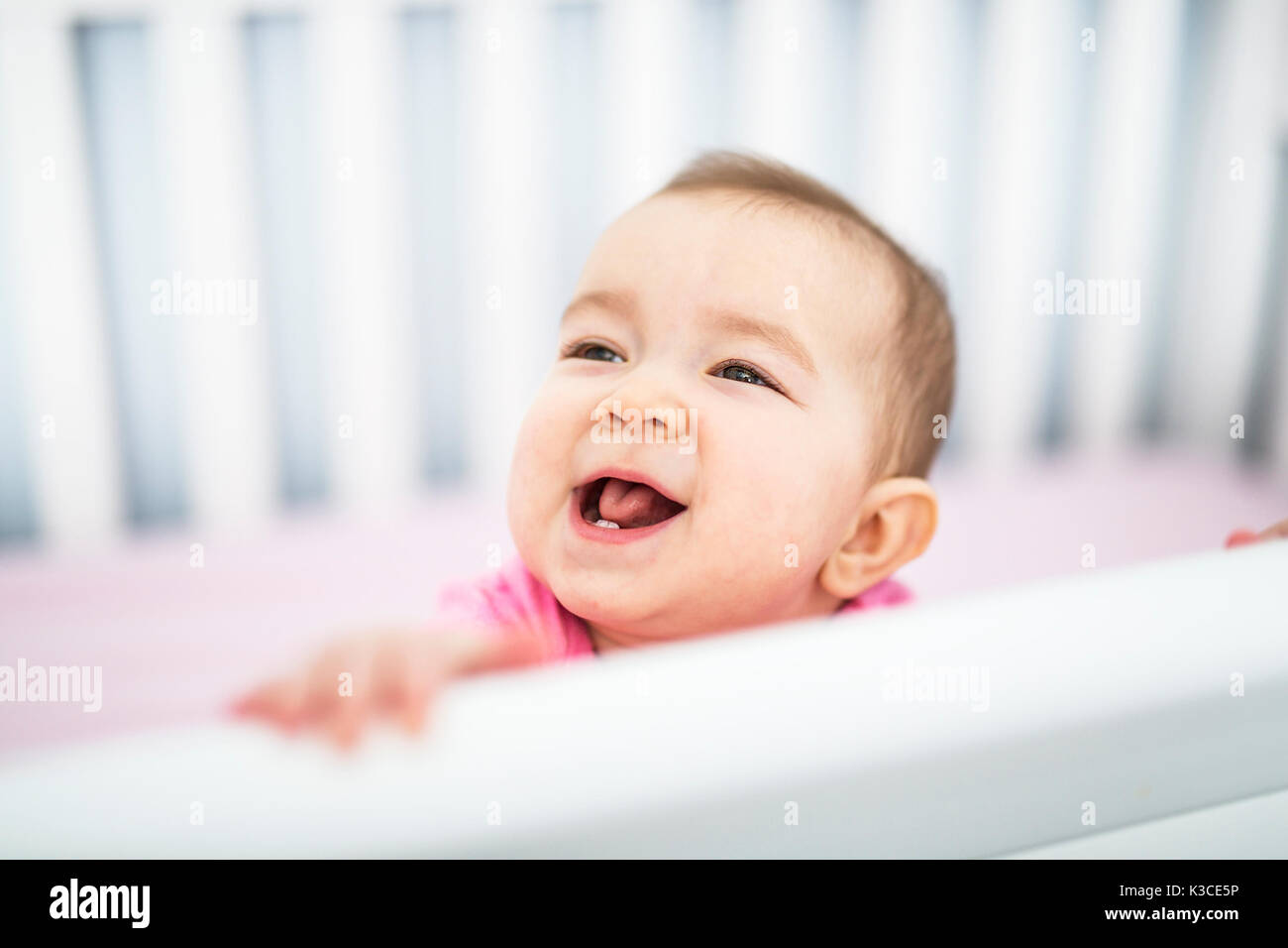 Infant baby resting and playing in his little baby bed Stock Photo - Alamy