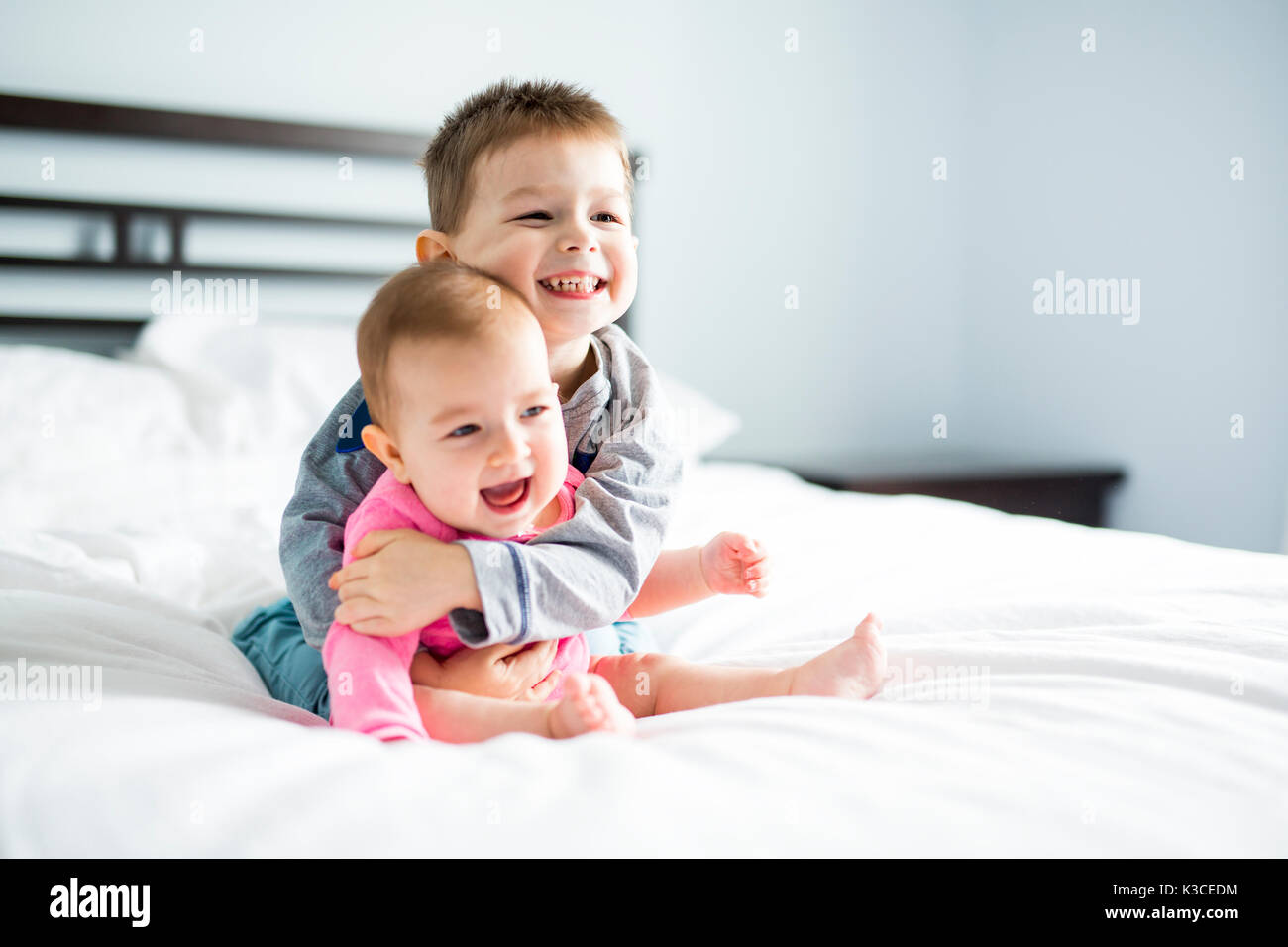 baby and his brother on bed Stock Photo - Alamy