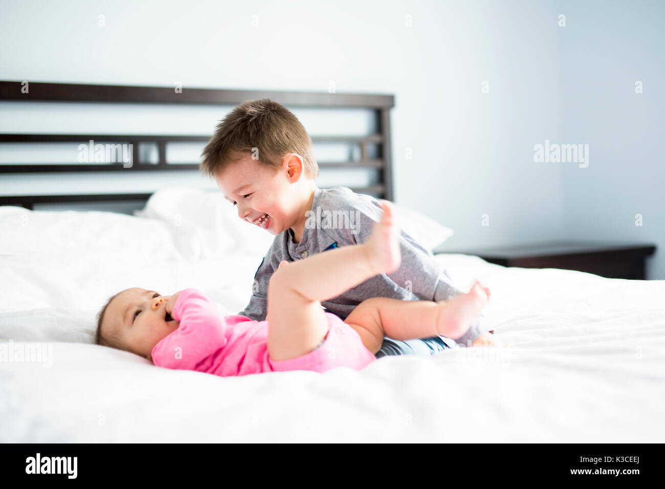 baby and his brother on bed Stock Photo - Alamy