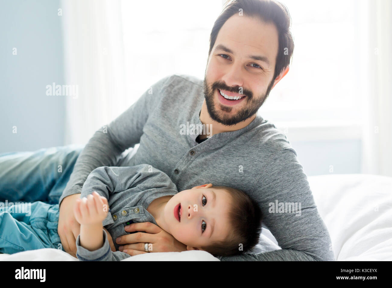 Father and son in bed, happy time on bed Stock Photo - Alamy