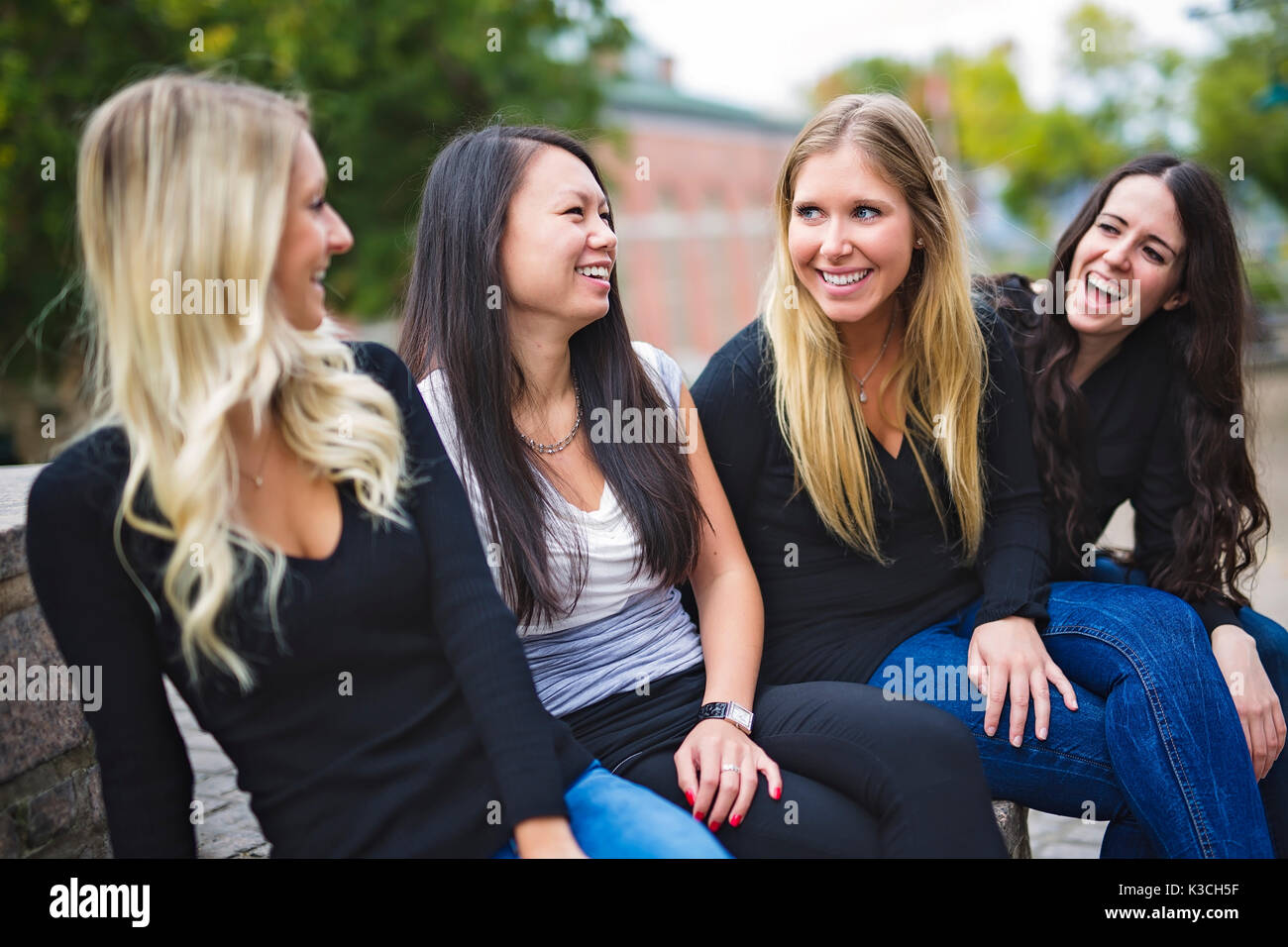 Four young good girl friend people in the city Stock Photo - Alamy