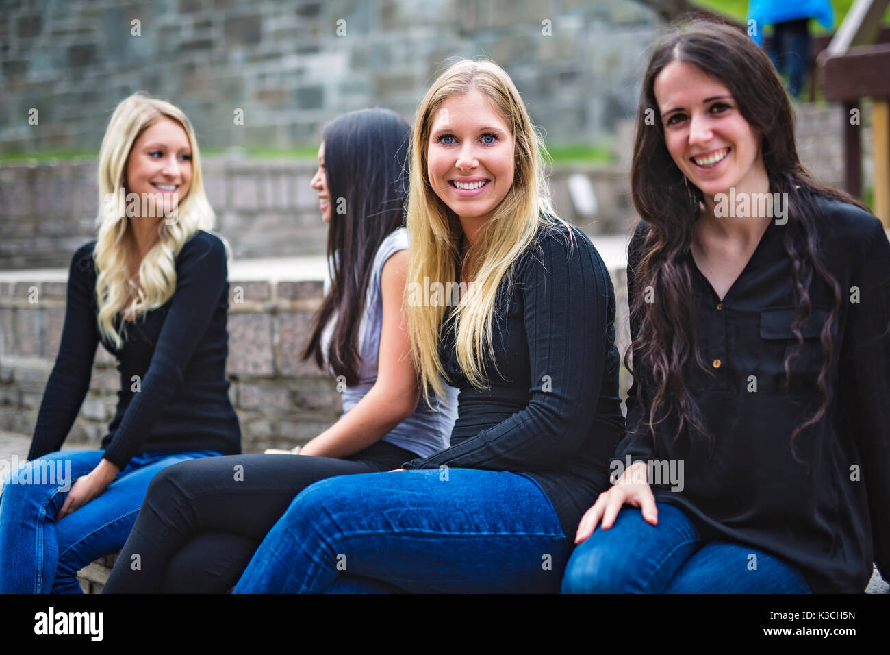Four young good girl friend people in the city Stock Photo - Alamy