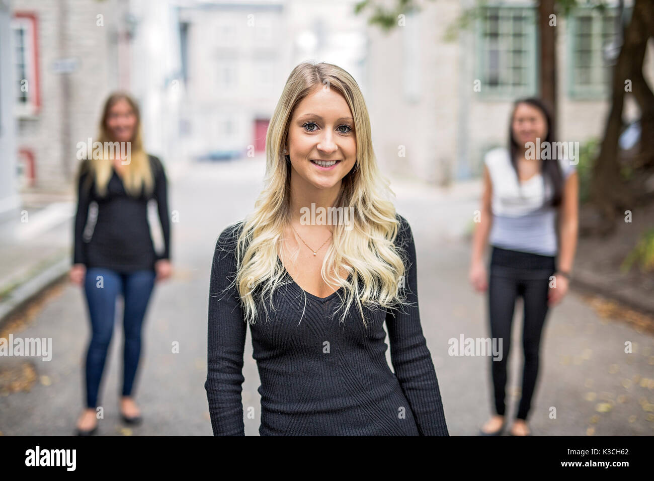 three young good girl friend people in the city Stock Photo - Alamy
