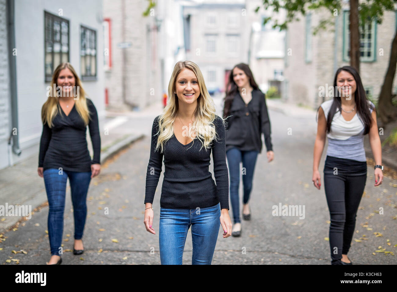 Four young good girl friend people in the city Stock Photo - Alamy