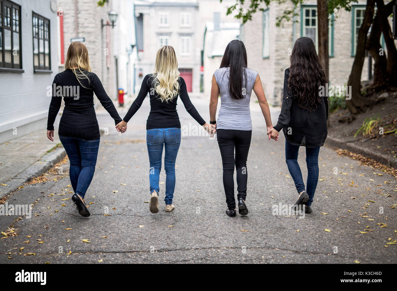 Four young good girl friend people in the city Stock Photo - Alamy