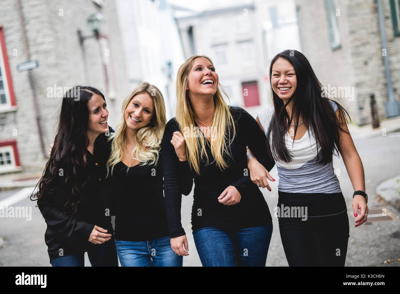 Four young good girl friend people in the city Stock Photo - Alamy