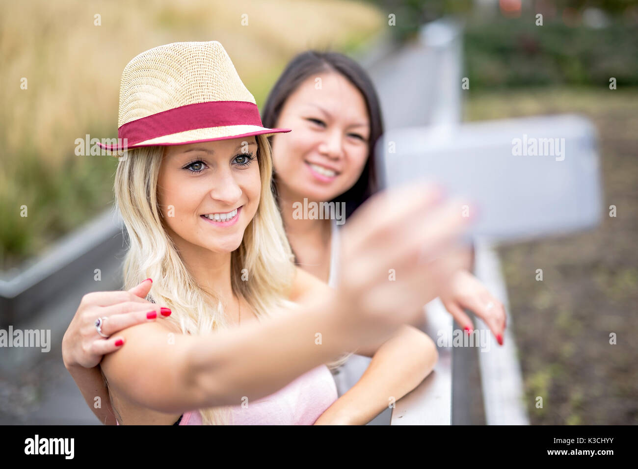 two beautiful young women having fun in the city Stock Photo - Alamy