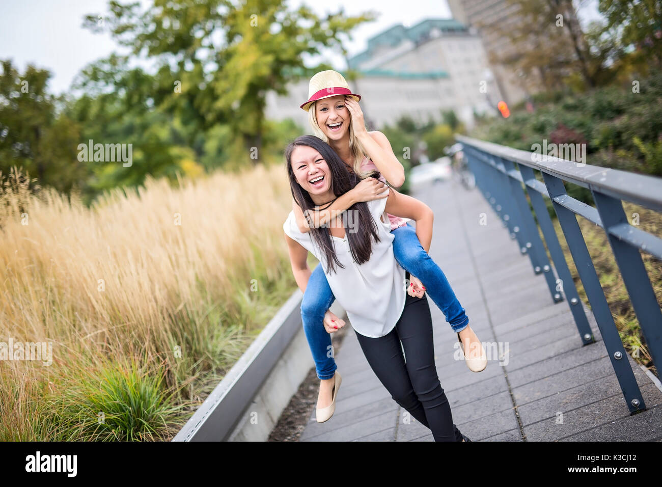 two beautiful young women having fun in the city Stock Photo - Alamy