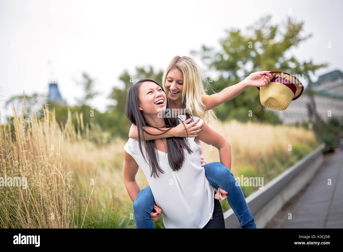 two beautiful young women having fun in the city Stock Photo - Alamy