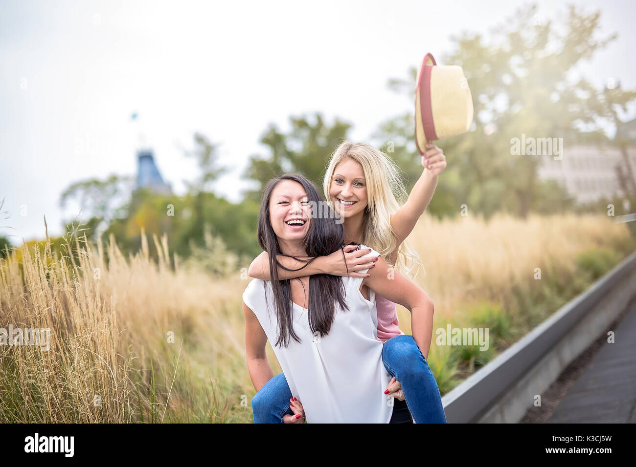 two beautiful young women having fun in the city Stock Photo - Alamy
