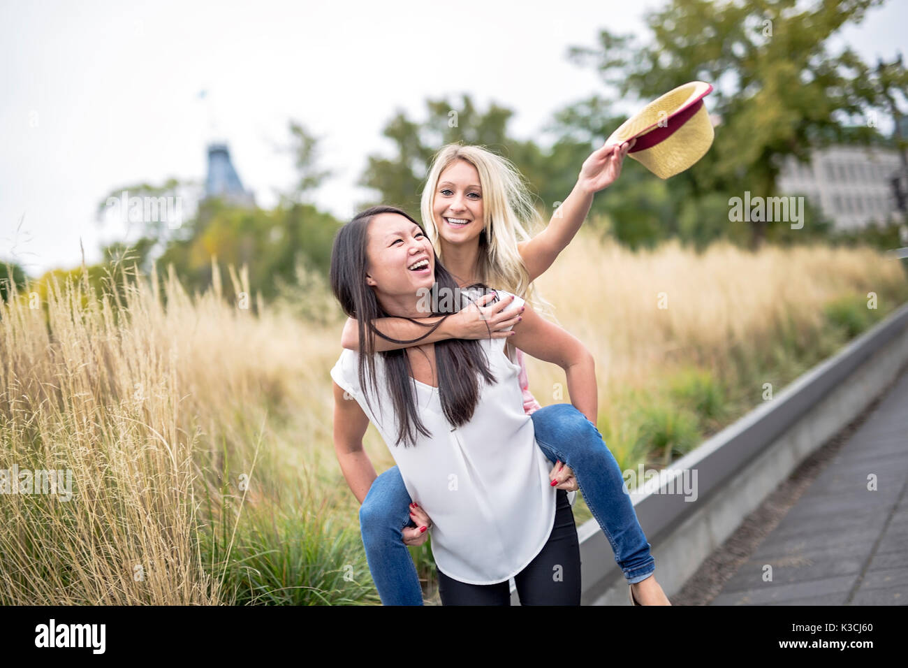 two beautiful young women having fun in the city Stock Photo - Alamy