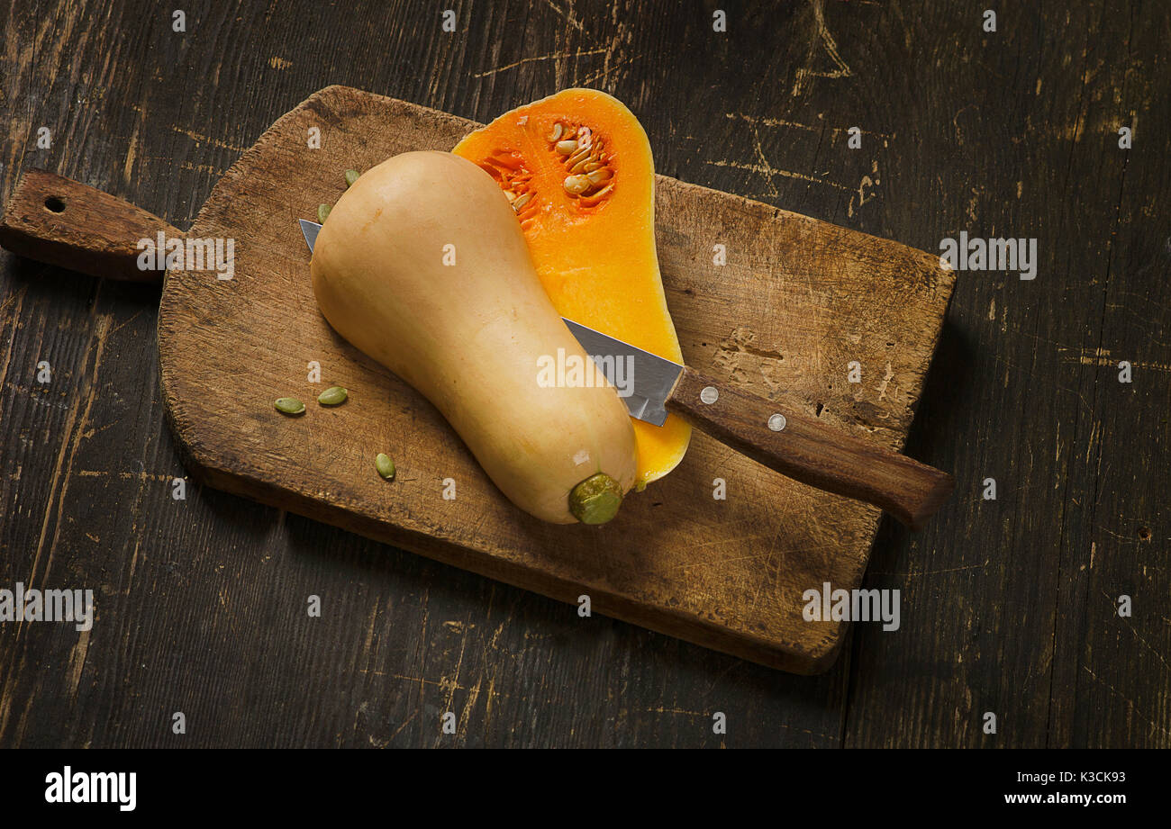 Butternut squash pumpkin on a rustic wooden background Stock Photo - Alamy