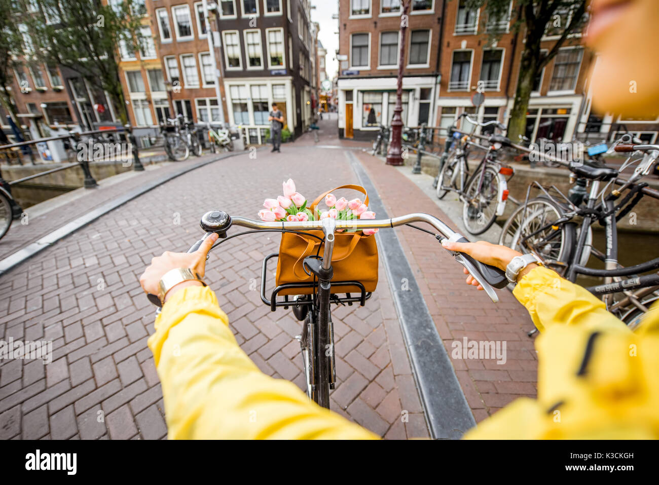 Riding a bicycle in Amsterdam Stock Photo - Alamy