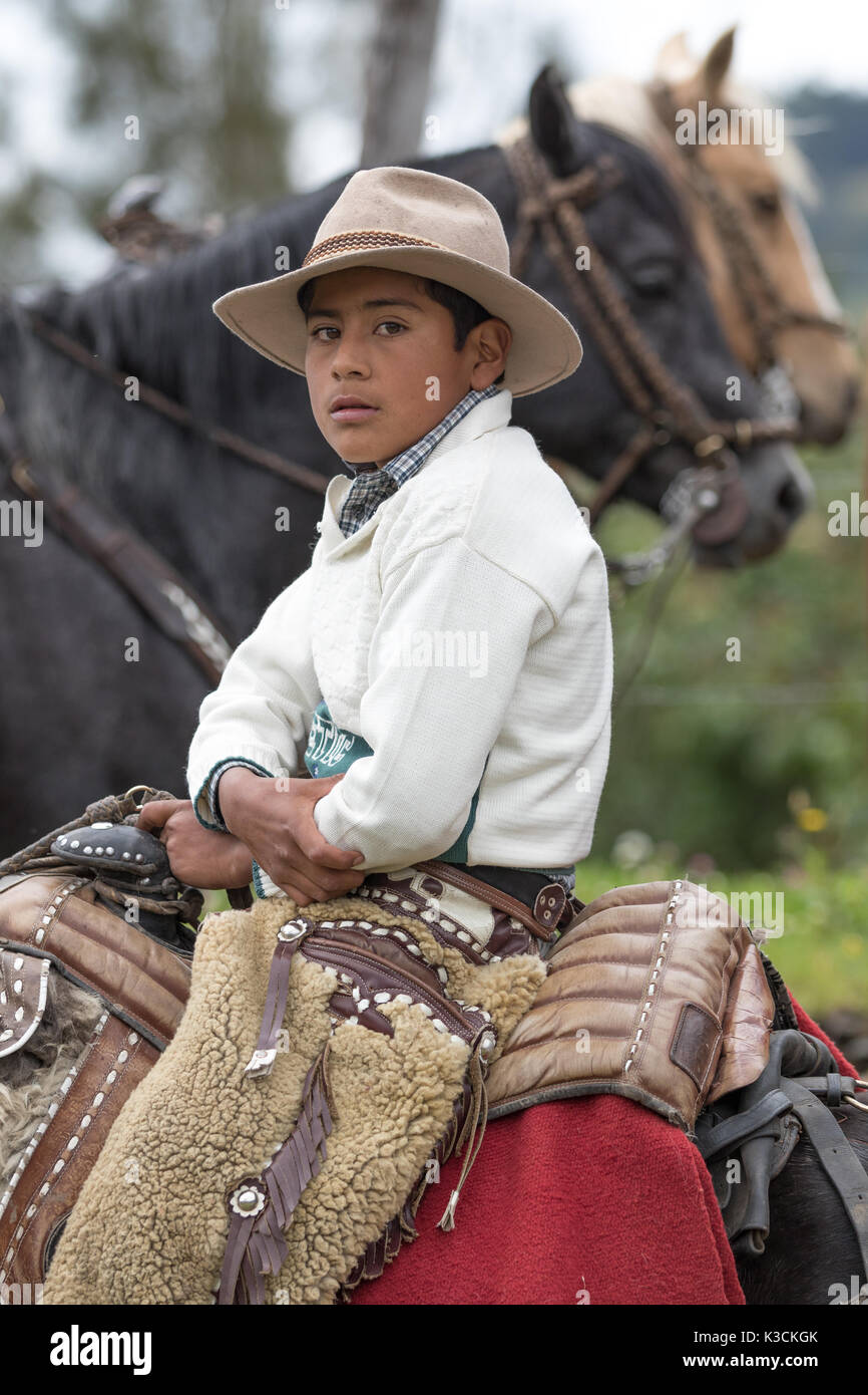 May 27, 2017 Sangolqui, Ecuador: young cowboy sitting in saddle wearing ...