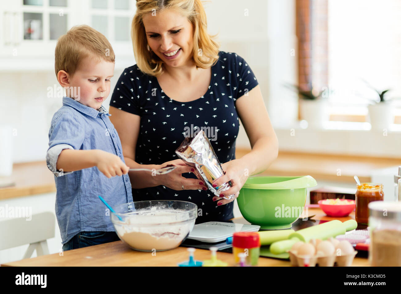 Happy mother and child in kitchen Stock Photo - Alamy