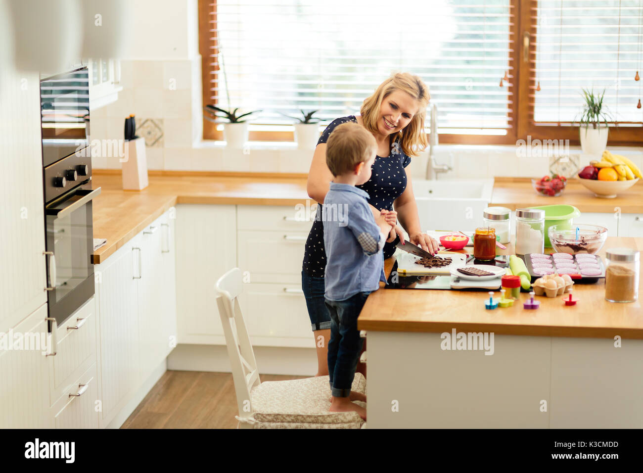 Child helping mother make cookies Stock Photo - Alamy