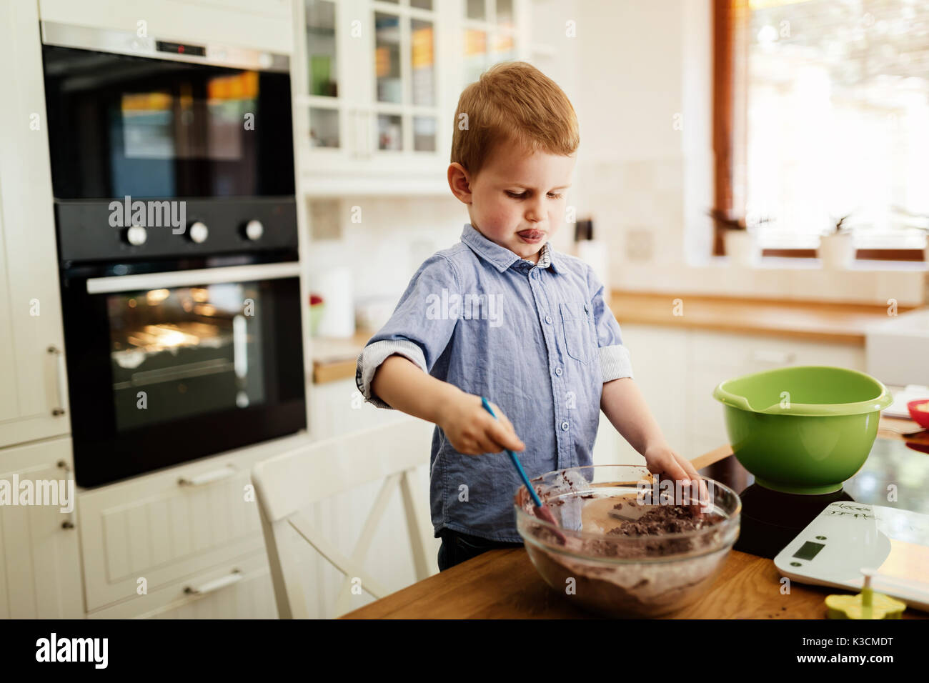 Cute child learning to become a chef Stock Photo - Alamy