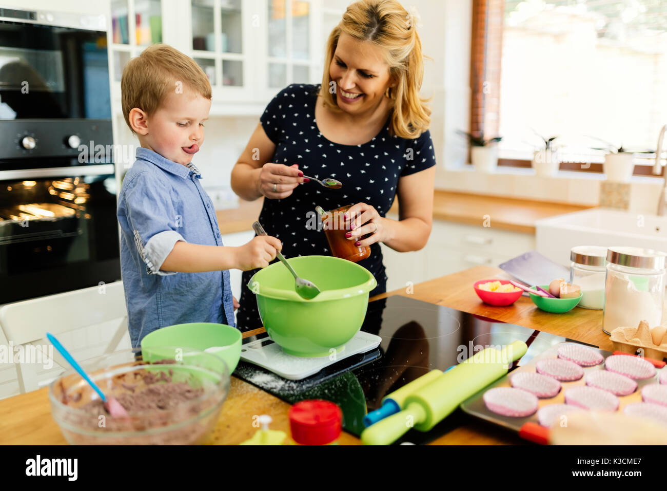 Beautiful child and mother baking Stock Photo - Alamy