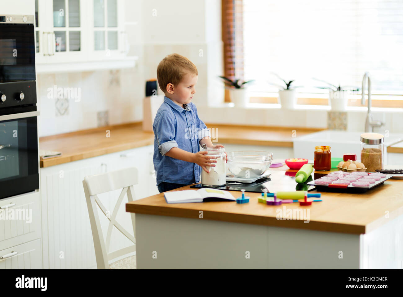 Cute child learning to become a chef Stock Photo - Alamy Cute child learning to become a chef Stock Photo - Alamy