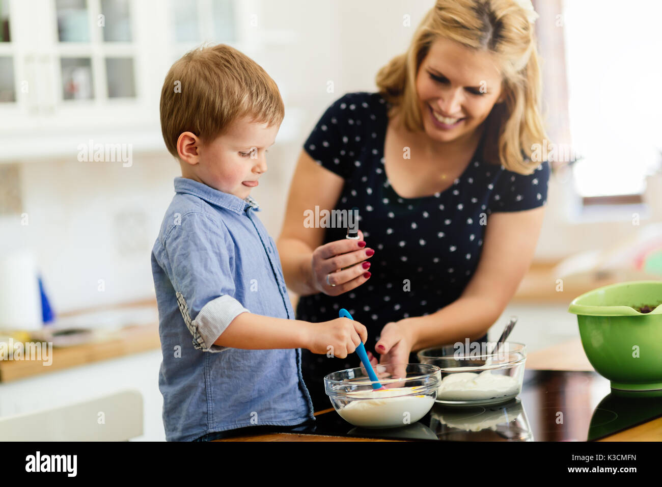 Child helping mother make cookies Stock Photo - Alamy