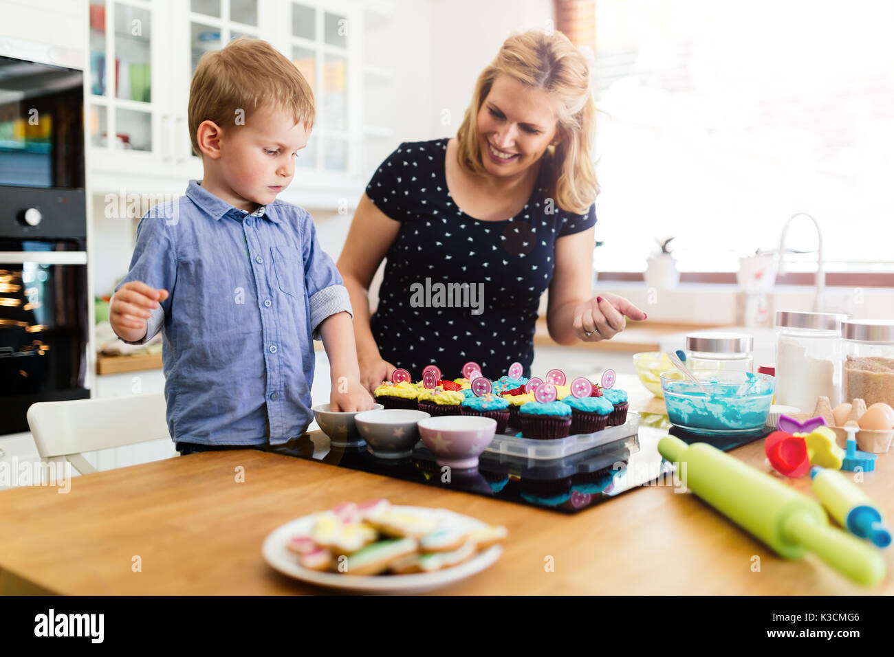 Child helping mother bake cookies Stock Photo - Alamy