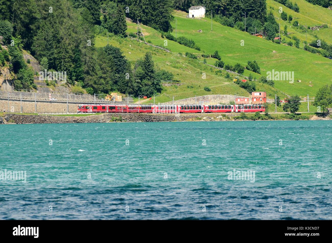 Swiss Mountain Train Bernina Express at Lake of Poschiavo Stock Photo ...