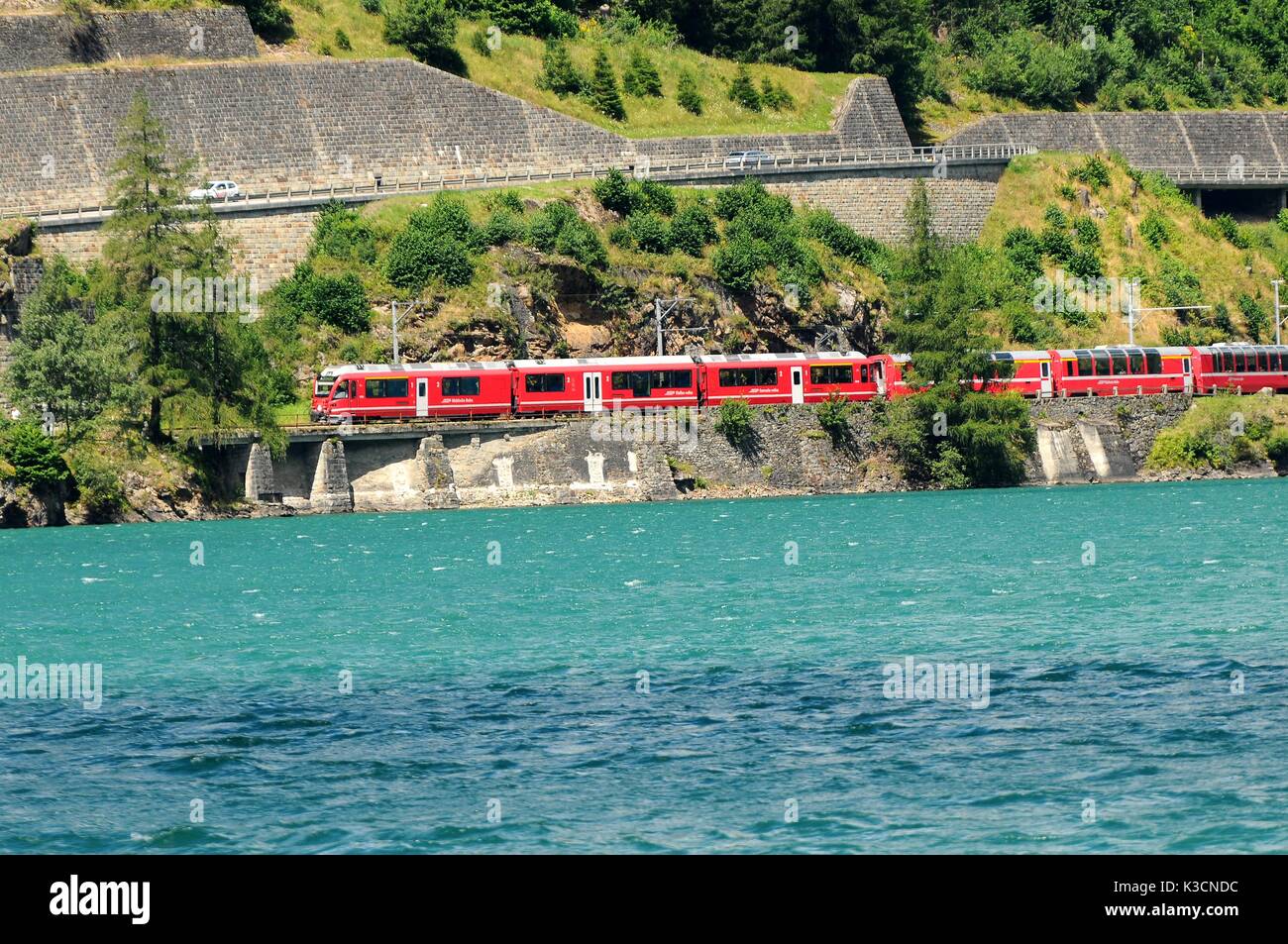 Swiss Mountain Train Bernina Express at Lake of Poschiavo Stock Photo ...