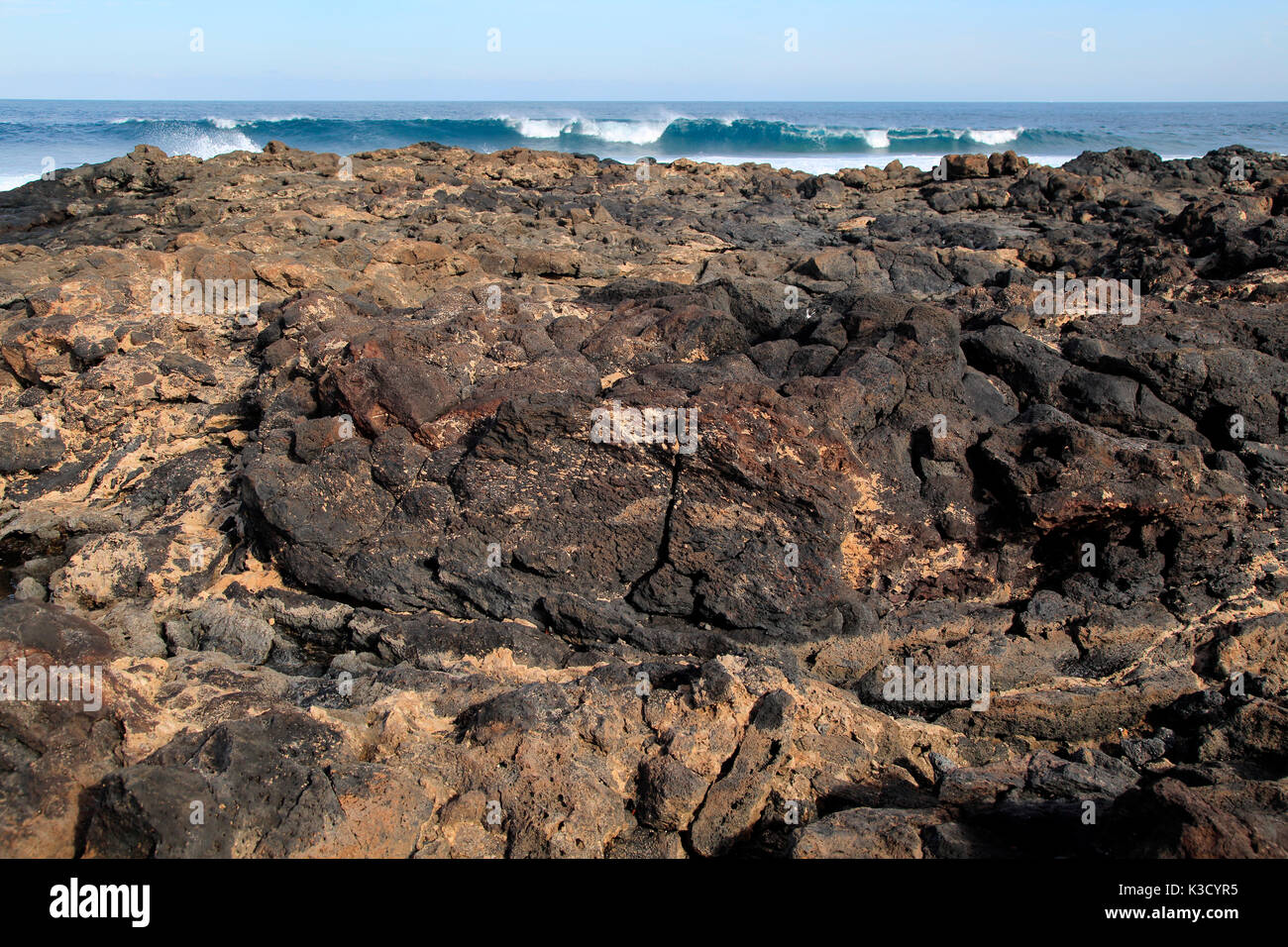 Lava flow volcanic rocks on beach near Majanicho on north coast of ...