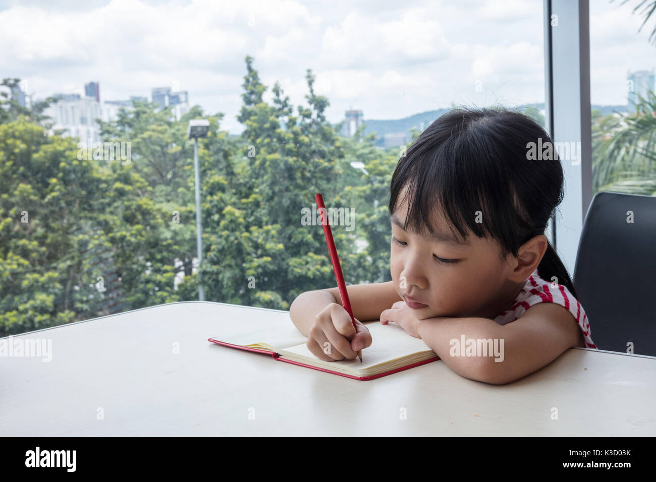 Asian little Chinese girl writing homework at home Stock Photo - Alamy