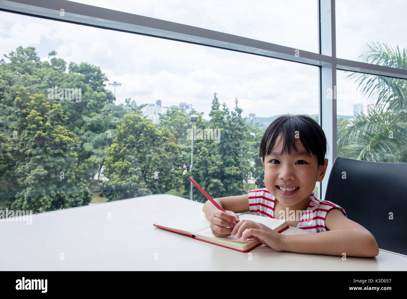 Asian little Chinese girl writing homework at home Stock Photo - Alamy