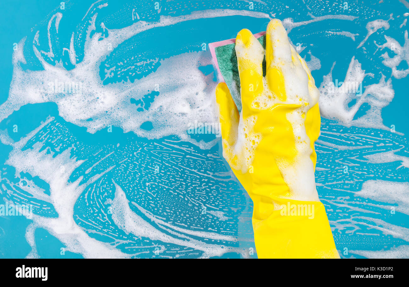 Cleaning conept, hand cleaning glass window pane with detergent and ...
