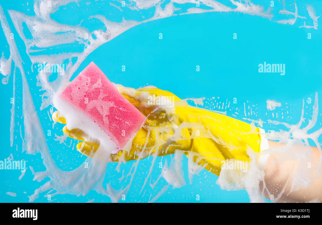 Cleaning conept, hand cleaning glass window pane with detergent and ...