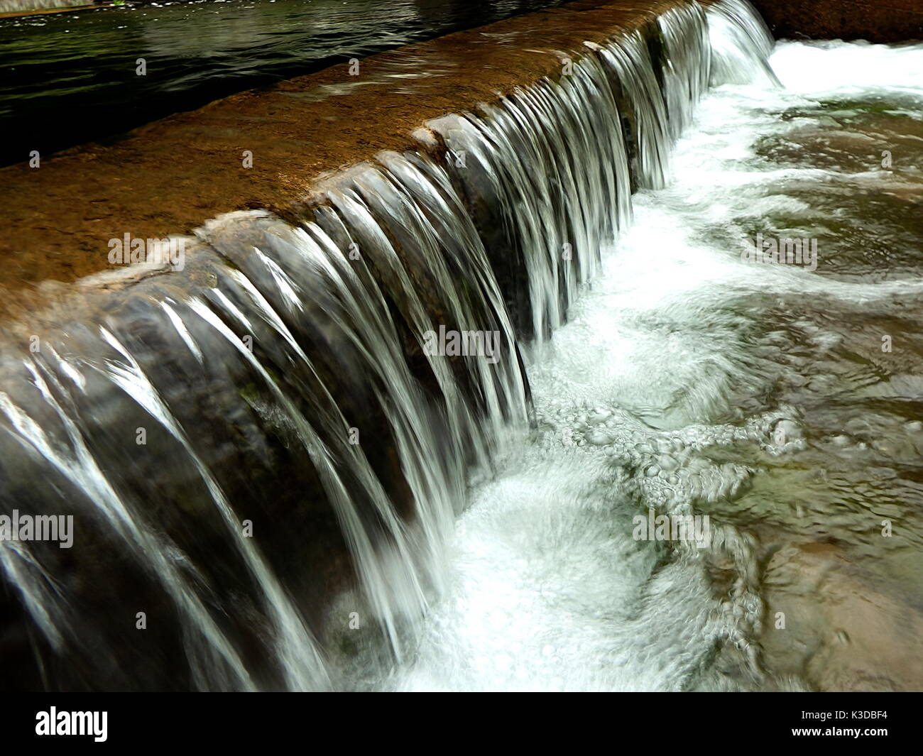 small waterfall, artificial cascade on the river Stock Photo - Alamy
