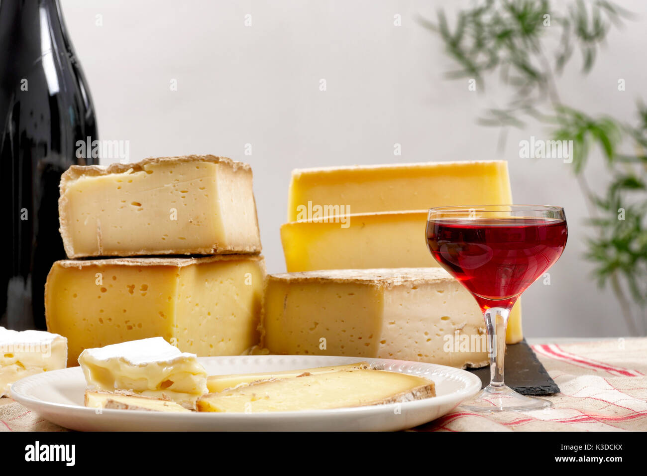 Different french cheeses with a glass of red wine Stock Photo - Alamy