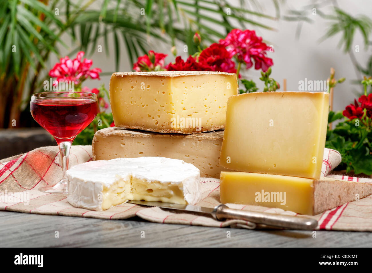 Different french cheeses with a glass of red wine Stock Photo - Alamy