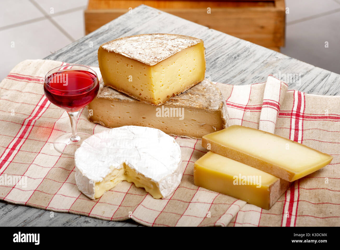 Different french cheeses with a glass of red wine Stock Photo - Alamy