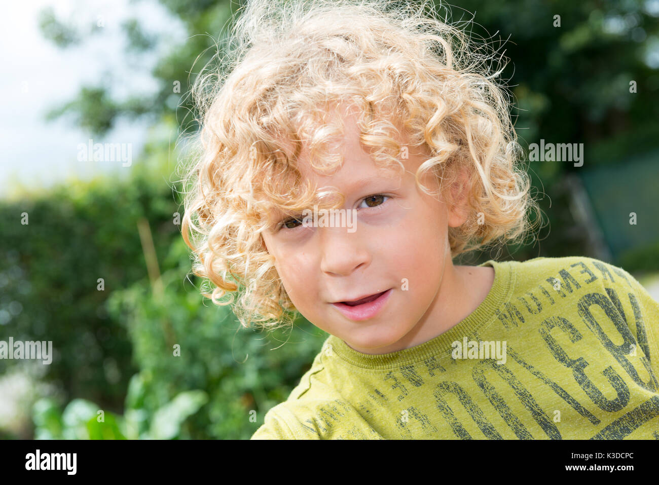 Portrait of a little boy with blond and curly hair Stock Photo - Alamy