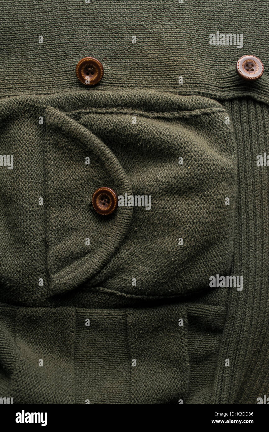 Knitted green wool jacket, made of natural wool fabrics. background ...