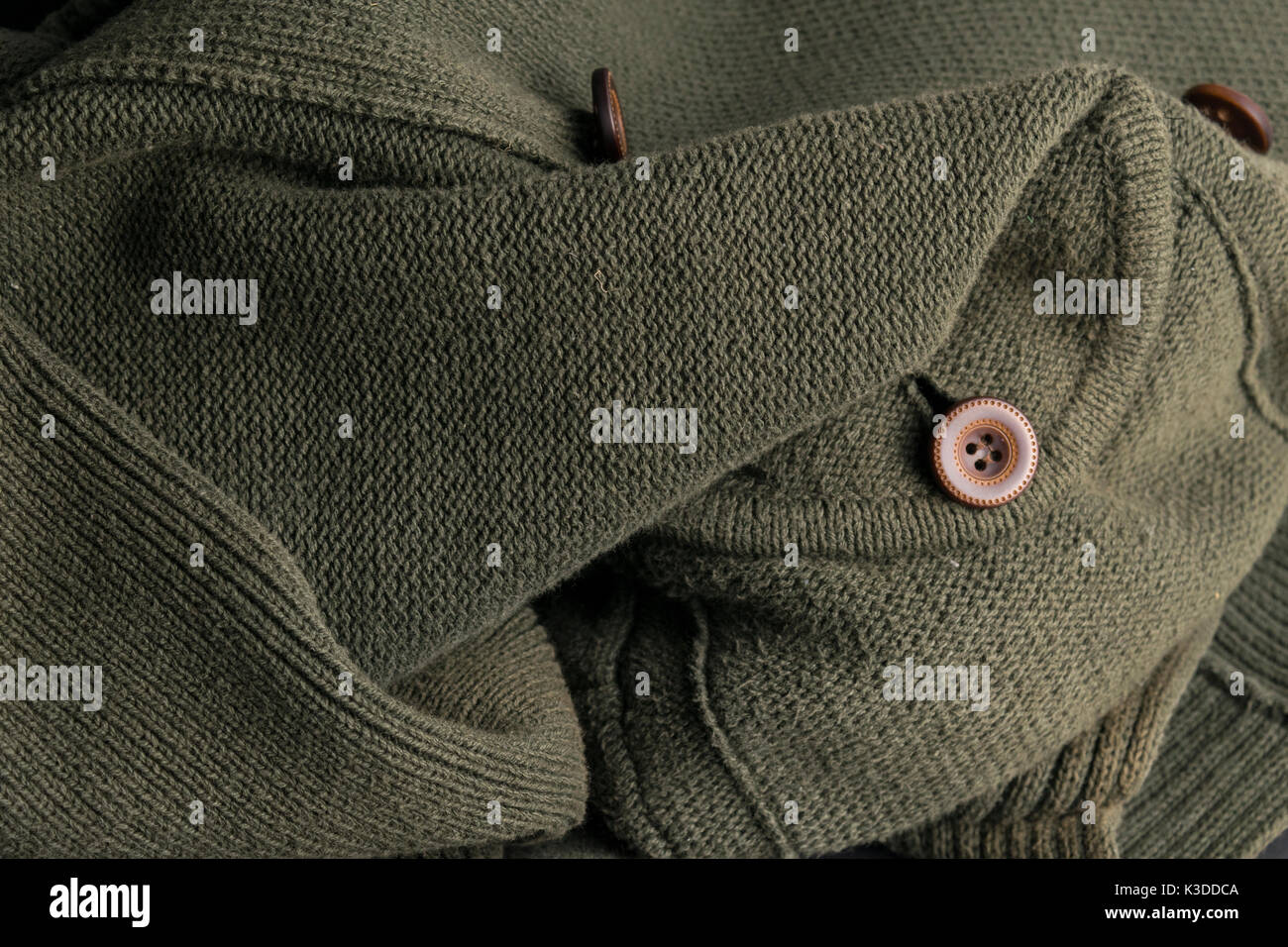 Knitted green wool jacket, made of natural wool fabrics. background ...