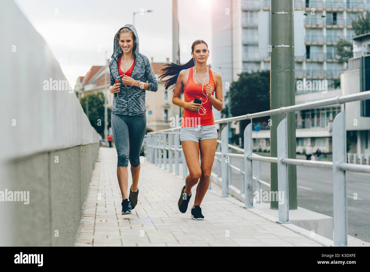 Active female joggers running outdoors Stock Photo - Alamy