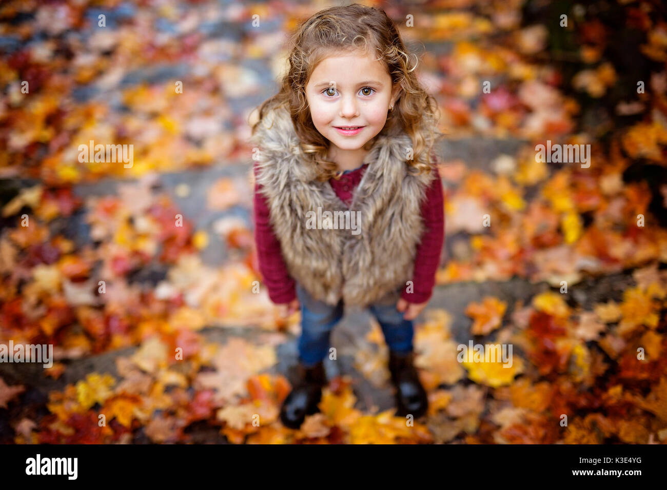 Adorable little girl in a autumn forest Stock Photo - Alamy