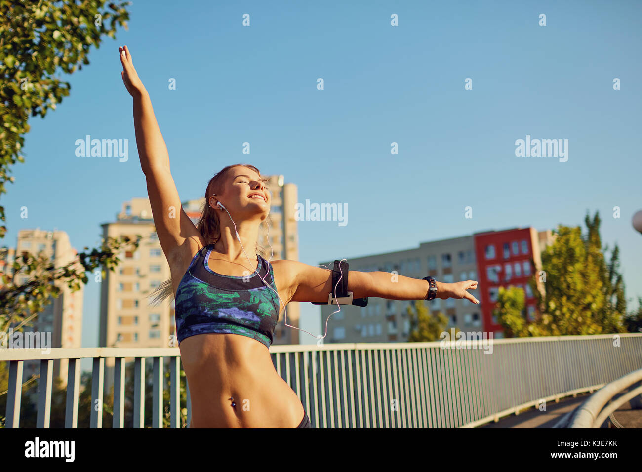 Girl runner happy after jogging raised her hands up Stock Photo - Alamy