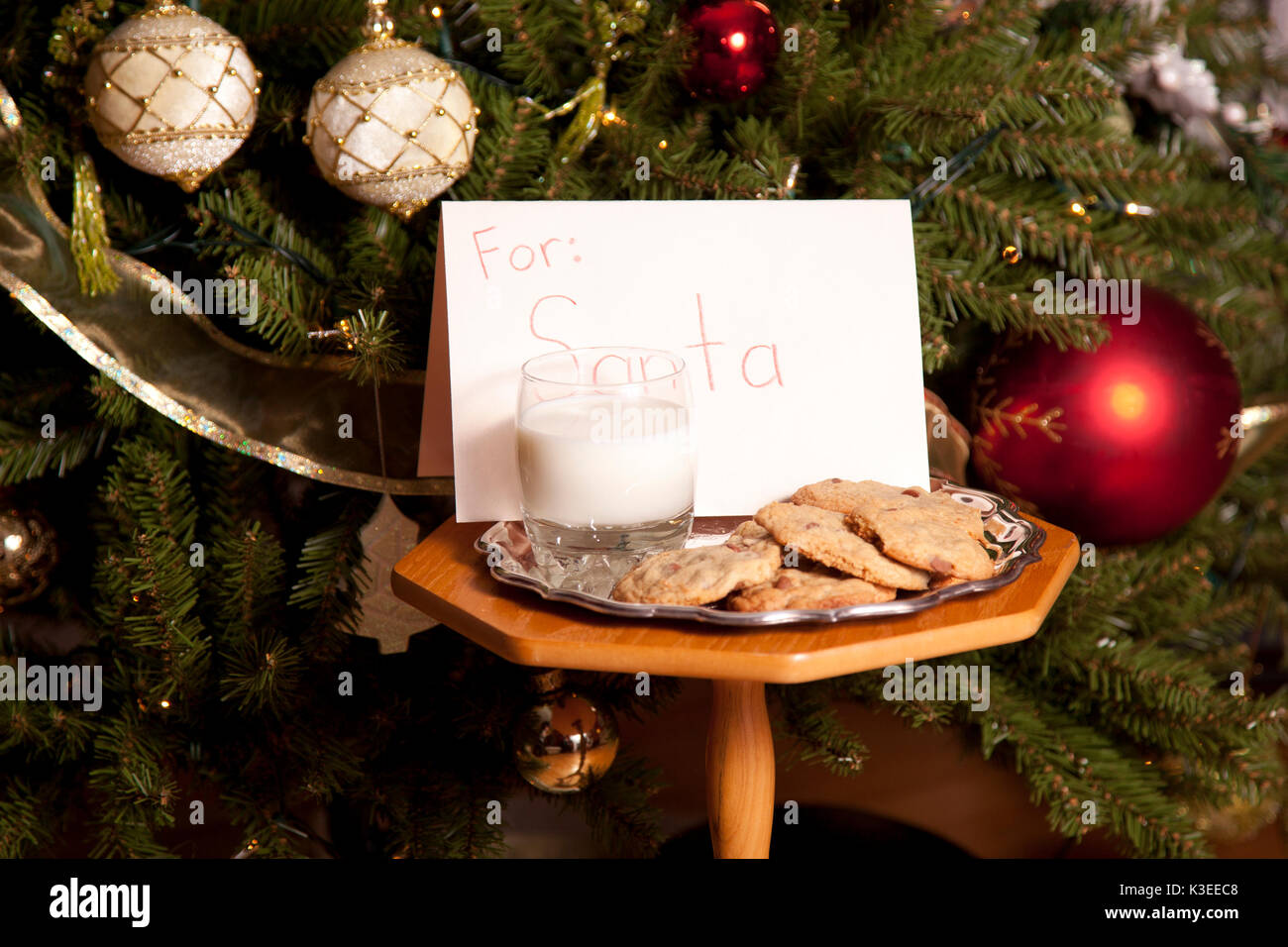 Milk and cookies in front of a Christmas tree for Santa Stock Photo - Alamy