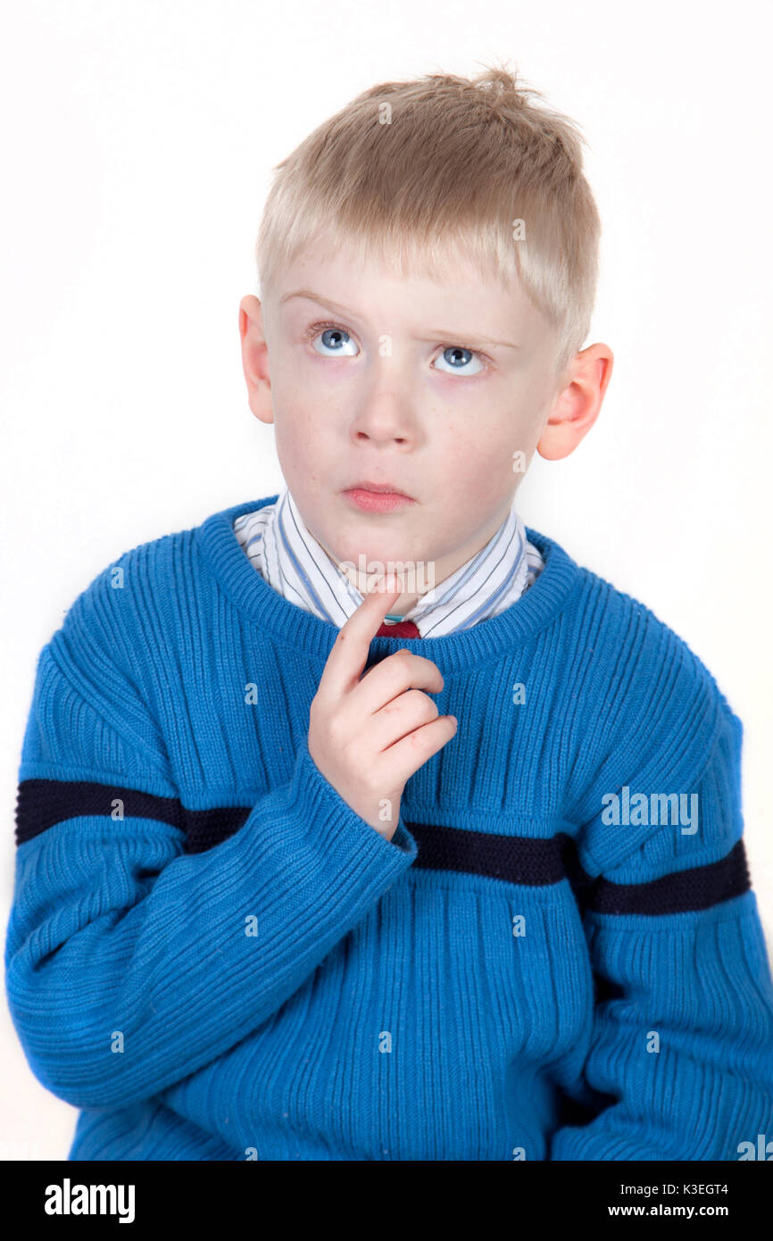 Young child poses while thinking Stock Photo - Alamy